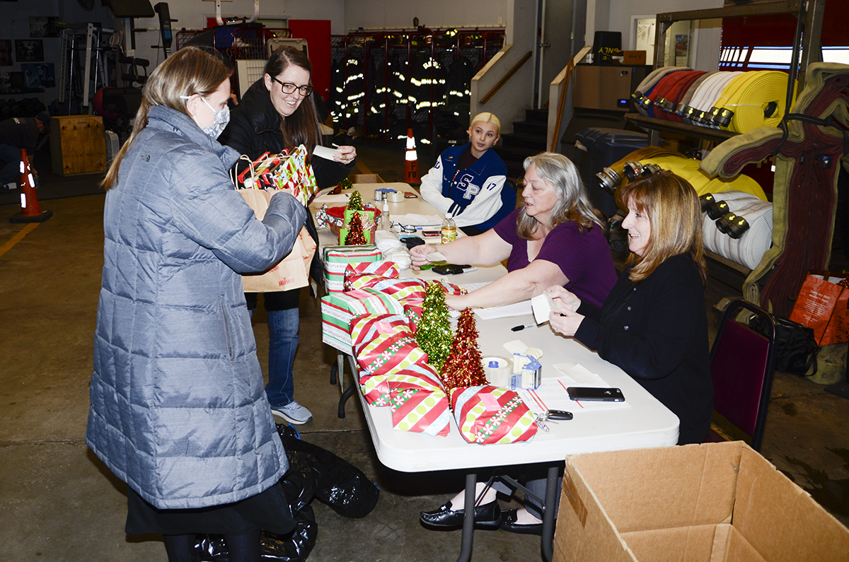 Santa’s helpers gather presents for his door-to-door visit on December ...